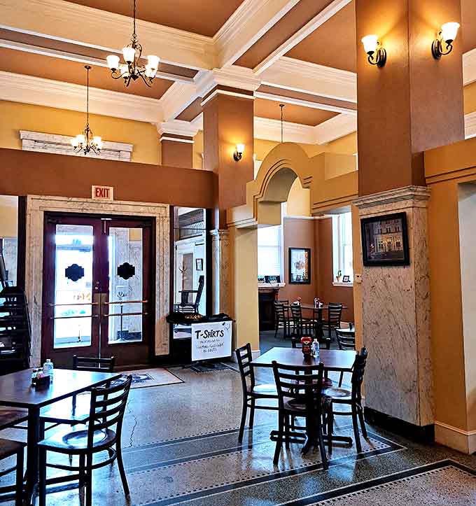 Marble columns and warm lighting create intimate dining areas within the grand space, perfect for savoring every bite in architectural splendor.