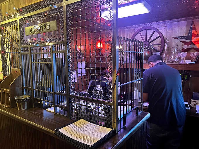 The historic cashier's cage adds a touch of vintage charm, reminiscent of old banks where transactions were conducted through ornate ironwork.