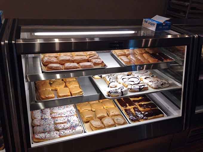 The display case gleams with possibilities, each shelf offering a different path to sweet contentment and happiness.