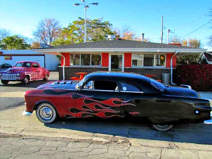 Classic cars find their spiritual home in the Old Town parking lot, where vintage automotive beauty complements the timeless appeal of comfort food.