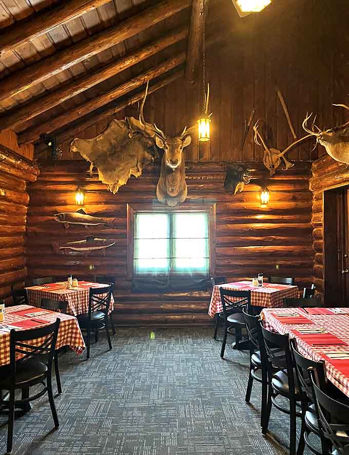 Dining under the watchful eyes of woodland creatures &ndash; rustic elegance meets North Woods charm in this intimate dining area.