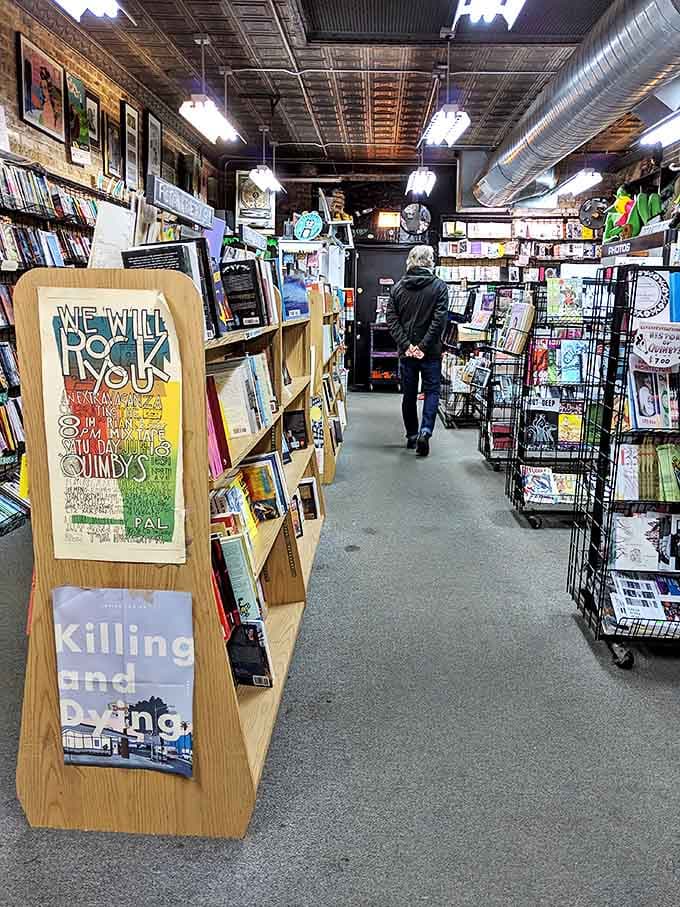 Browsing customers navigate narrow pathways between shelves, each turn revealing new literary worlds waiting to be discovered.