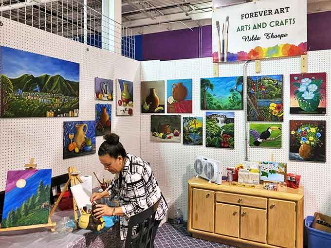 A local artist brings blank canvases to life in her booth, where creativity flourishes under fluorescent lights and inspiration knows no season.