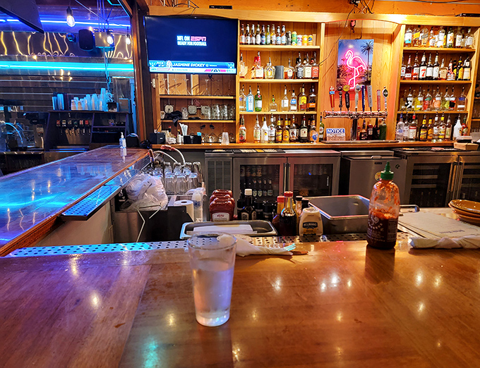 The bar isn't just where drinks are made&mdash;it's where stories are shared. That pink flamingo neon sign winks at you like it knows something you don't.