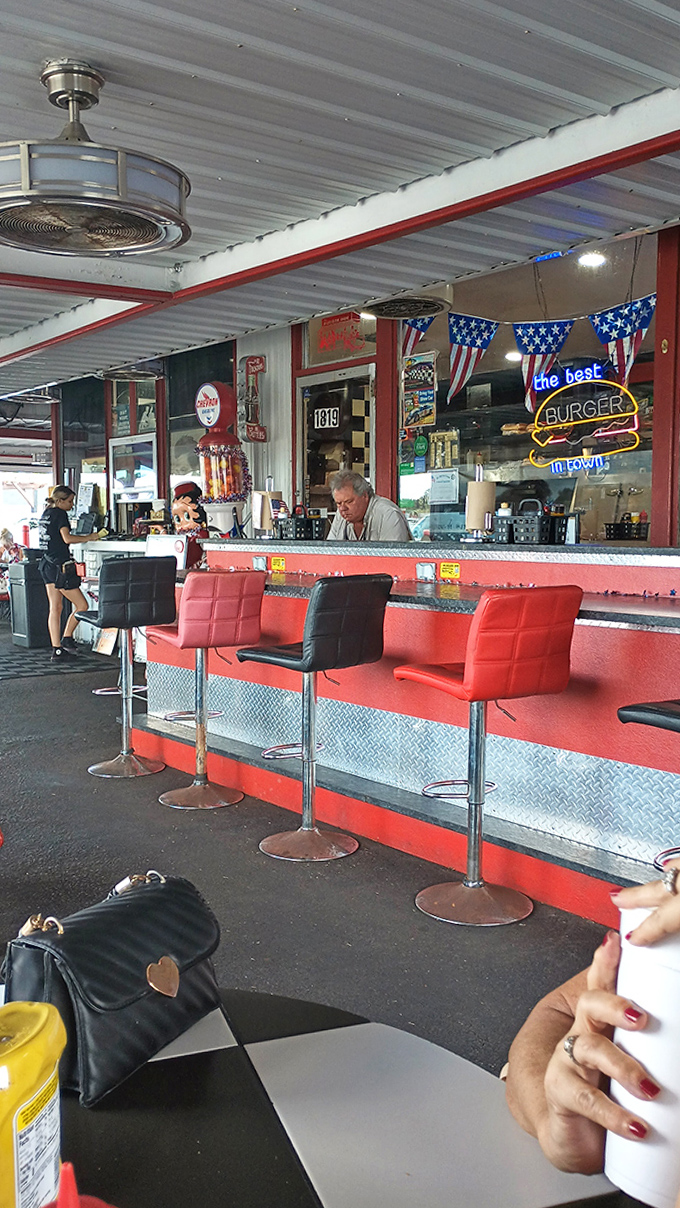 The counter area buzzes with energy as staff craft burgers with the confidence that comes from decades of perfecting their craft.