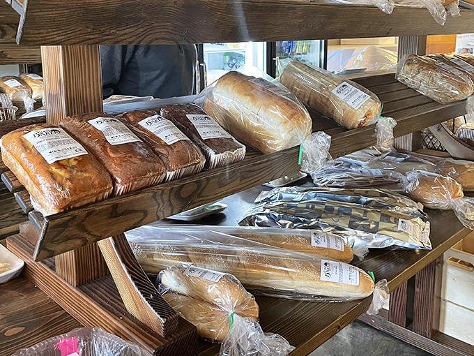 Fresh-baked bread lines wooden shelves, each loaf promising sandwiches that could make lunch the day's main event.
