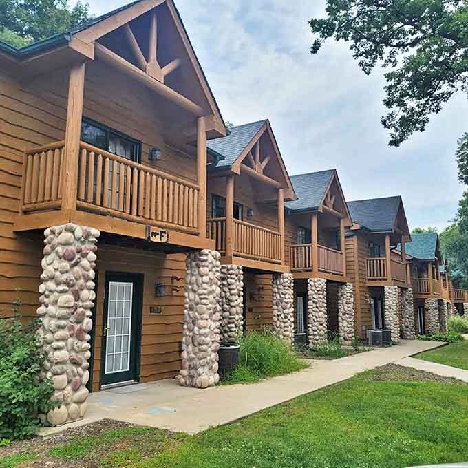 Cabin exteriors blend harmoniously with the natural surroundings, offering private retreats with stone accents and covered porches for morning coffee.