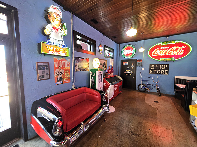 That red vinyl car-seat couch isn't just furniture – it's an invitation to sit in automotive history while sipping your chocolate malt.