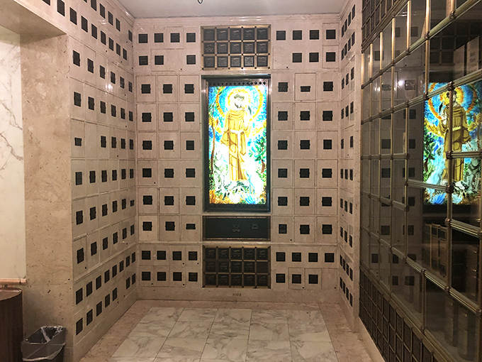 Illuminated stained glass brings warmth to this columbarium, where modern memorial practices meet traditional sacred art.