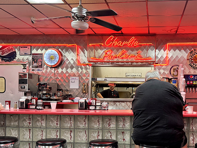 The beating heart of the diner &ndash; where neon glows warm welcome and counter seats offer front-row views to short-order culinary theater.
