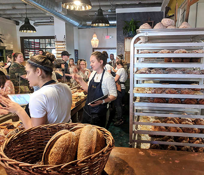 Customers and Staff: The morning rush creates a ballet of efficiency as staff navigate the delicate dance of serving eager pastry pilgrims.