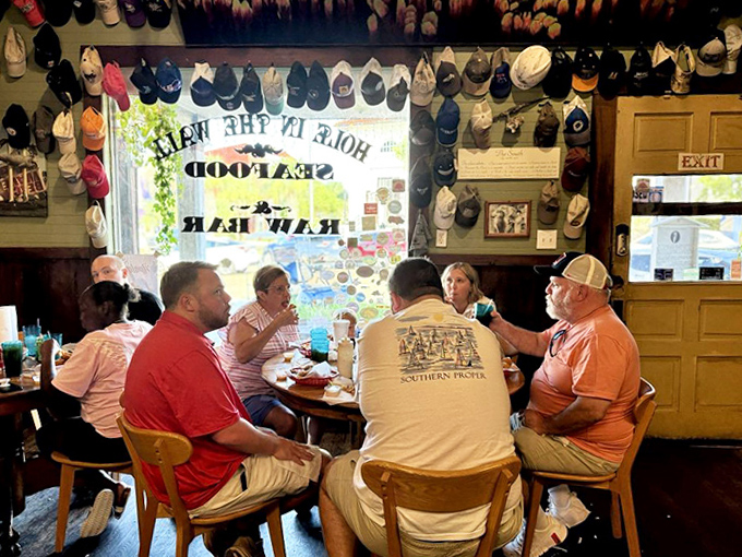 Conversations flow as freely as the sweet tea at these wooden tables, where strangers often become friends over shared plates of seafood.