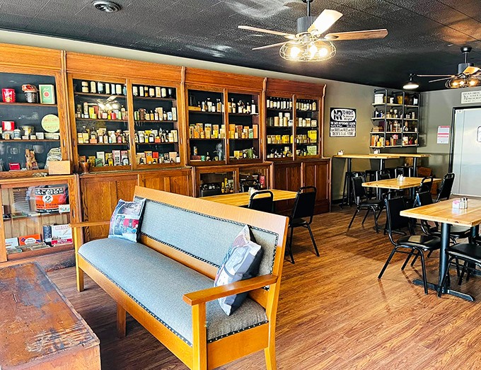 A community living room &ndash; simple tables, wooden floors, and comfortable seating create a space where strangers become friends over great food.