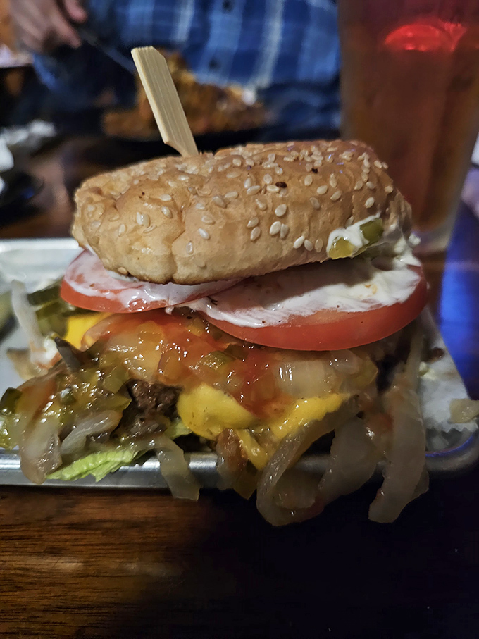 Fully-loaded cheeseburger: A towering achievement of beef, cheese, fresh vegetables, and special sauce that requires both hands, several napkins, and absolutely no regrets.