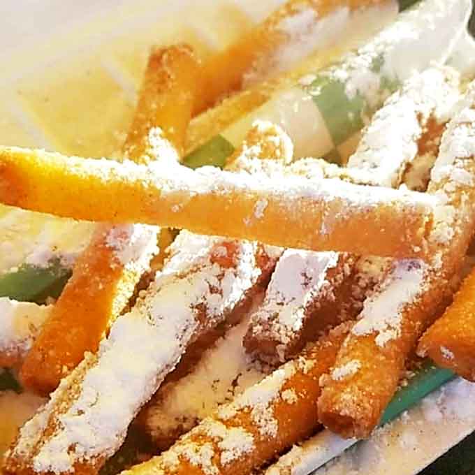 Funnel cake fries prove that sometimes the best innovations come from making classic treats easier to eat while walking around.