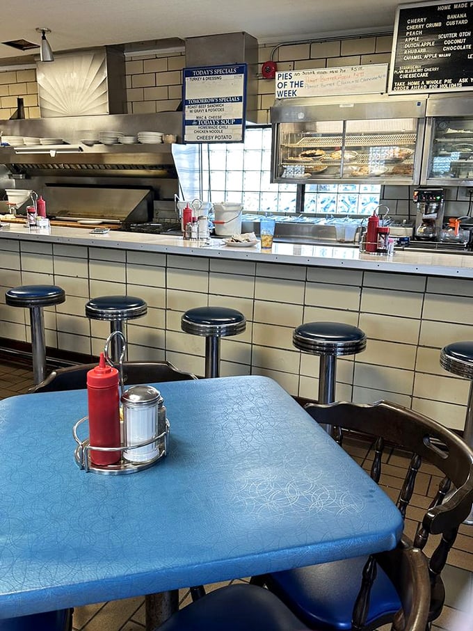 Inside: Cream-colored tile walls and blue tables create the perfect backdrop for memories being made over plates of food that taste like childhood – only better.