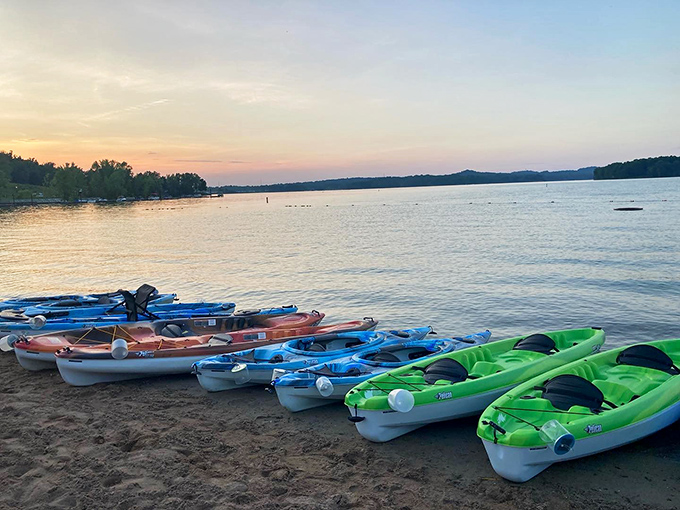 Colorful flotilla at sunset &ndash; these kayaks aren't just waiting for tomorrow's paddlers, they're resting after today's adventures.