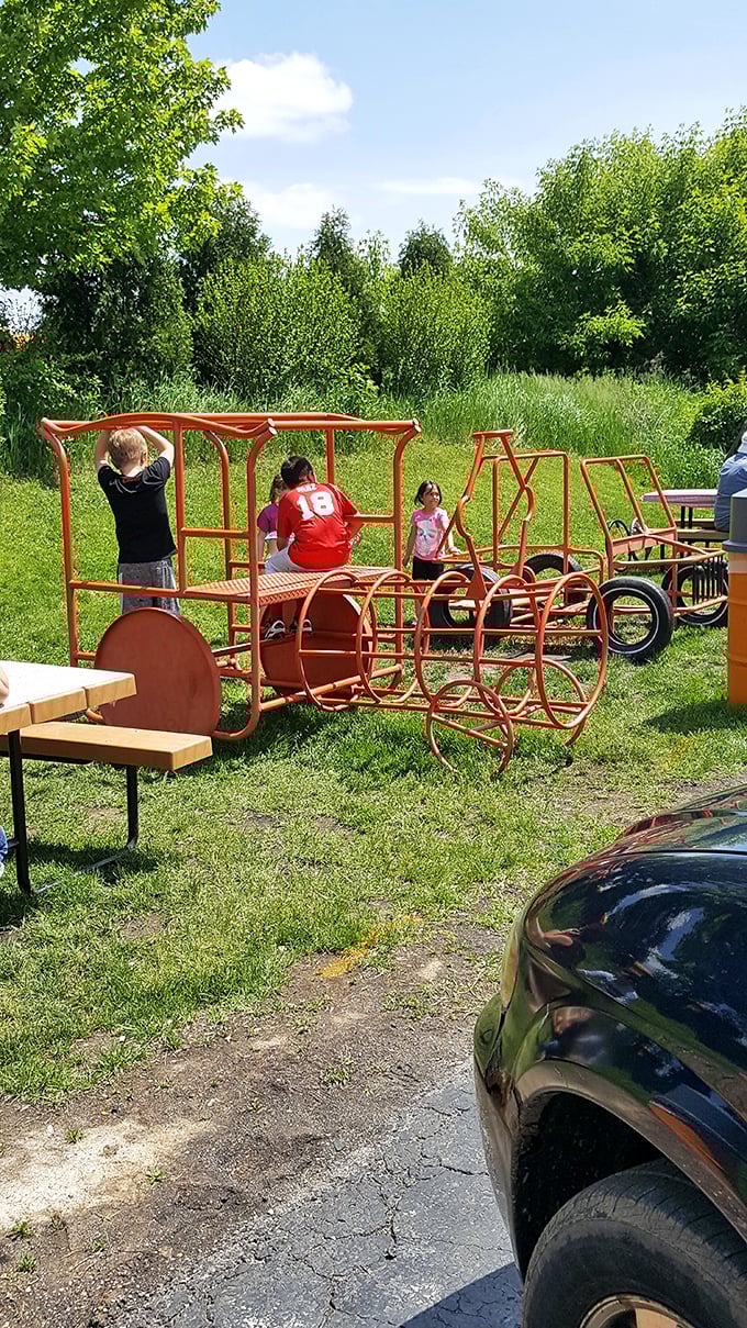 The playground's train-shaped equipment gives kids something to climb on while parents finish their meals – family-friendly dining at its best.
