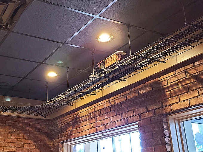 The miniature train chugging along ceiling tracks isn't just dinner – it's dinner and a show, mesmerizing diners young and old with every circuit.