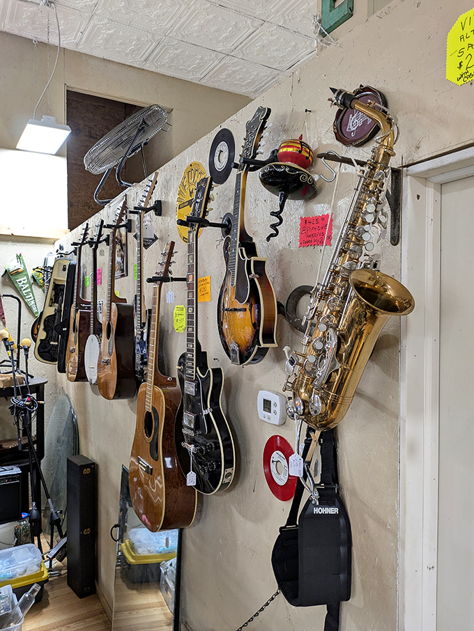 The wall of musical instruments stands ready to play again, each guitar and saxophone carrying the invisible fingerprints of previous musicians.
