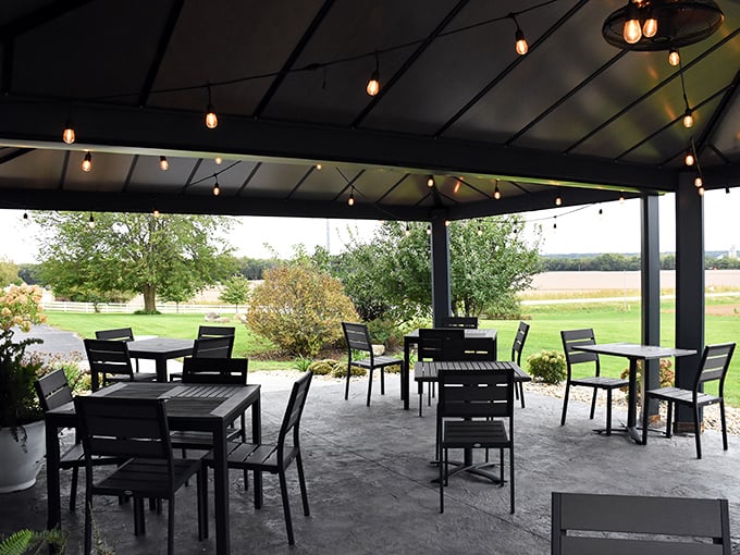 The outdoor patio offers a serene escape, where string lights twinkle above and the surrounding farmland reminds you of the restaurant's authentic roots.