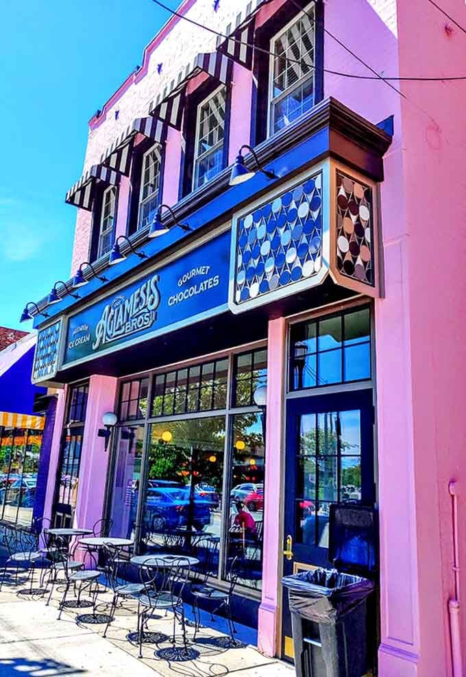 Sunshine bathes the cheerful exterior, where outdoor tables invite passersby to pause and indulge in a moment of sweet serenity.
