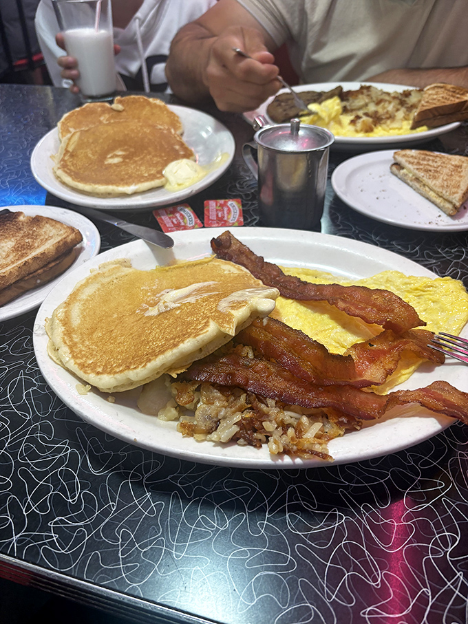 The breakfast trinity: golden pancakes, crispy bacon, and eggs &ndash; a plate that has launched a thousand good days across America.