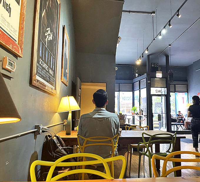 Yellow chairs provide cheerful contrast against gray walls adorned with vintage movie posters &ndash; the perfect setting for both productivity and relaxation.