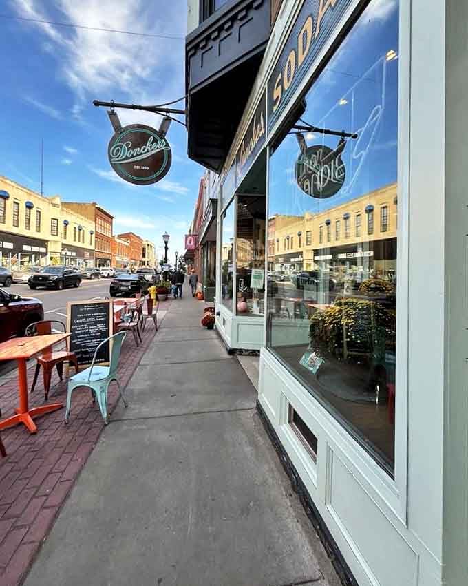 The Root Beer Stande sign stands tall against the sky, a beacon of culinary nostalgia that's been guiding hungry travelers for generations.