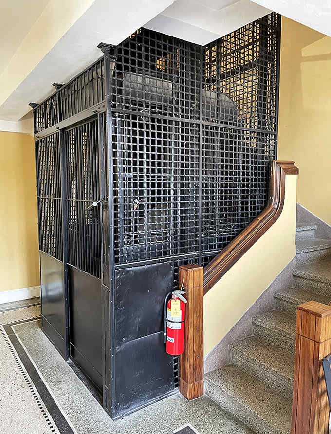 The original bank architecture creates unique spaces throughout the restaurant, including this stunning staircase and elevator cage.