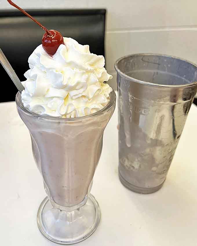 Classic strawberry milkshake served the old-fashioned way, because some things should never change.