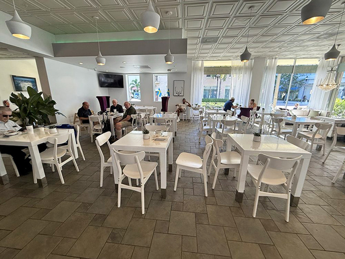 Tables: The bright, airy dining room where coffee cups steam and conversations flow &ndash; Scandinavian design meets Florida sunshine in perfect harmony.