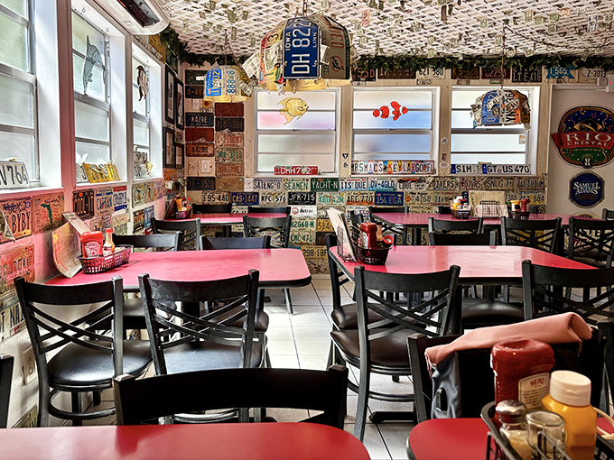 Red tables pop against the license plate backdrop, creating a dining room where every meal feels like a celebration of road trips and seafood discoveries.