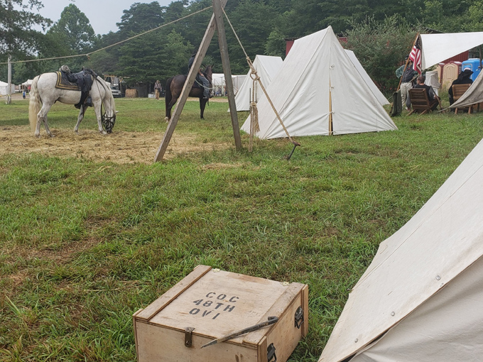 Canvas tents and simple furnishings show how military camps operated during the frontier expansion era.