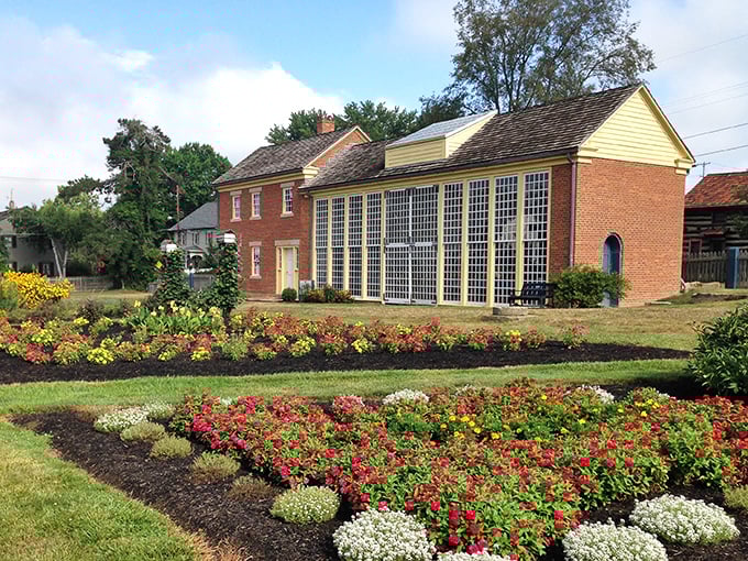 The Garden House stands sentinel over geometric flower beds that burst with color, proving that German precision extends from engineering to horticulture.