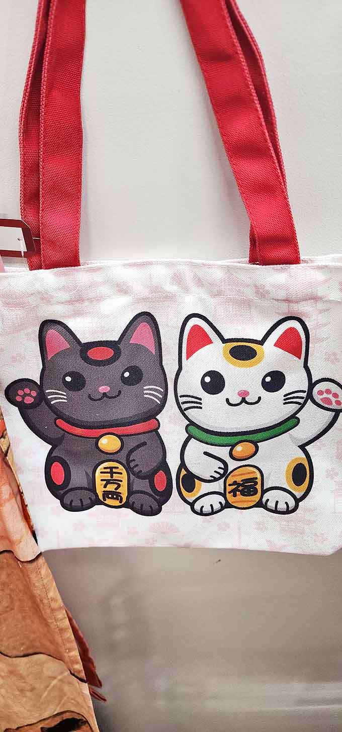 Even the merchandise carries the lucky cat charm &ndash; this tote bag features both traditional white and protective black Maneki-neko.