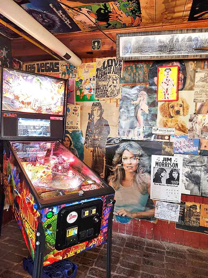 The vintage pinball machine stands ready in the corner, surrounded by decades of memorabilia that tell stories between bites.
