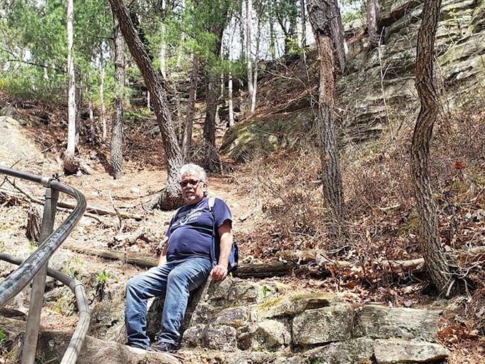 A moment of well-earned rest on Mill Bluff's historic stone steps. Each hiker adds their story to the thousands who've paused here before.
