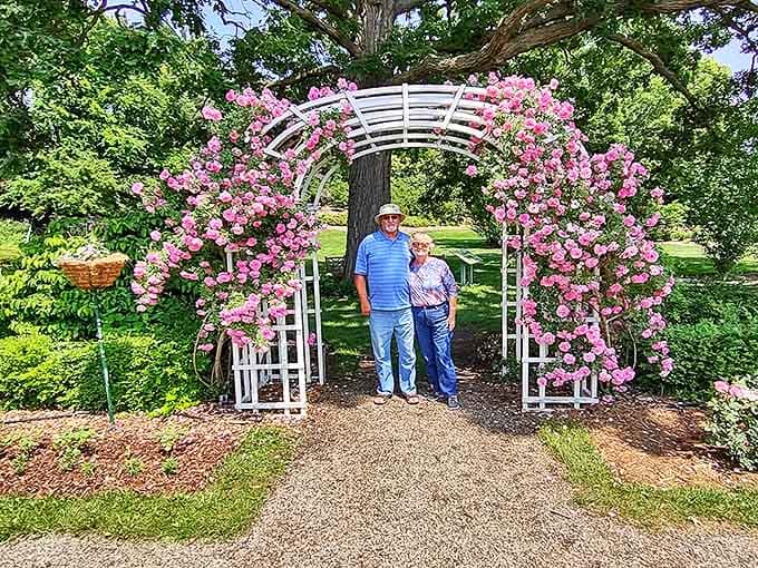 Visitors pause beneath a spectacular rose-covered arbor &ndash; the kind of romantic spot that's witnessed countless marriage proposals and anniversary kisses.