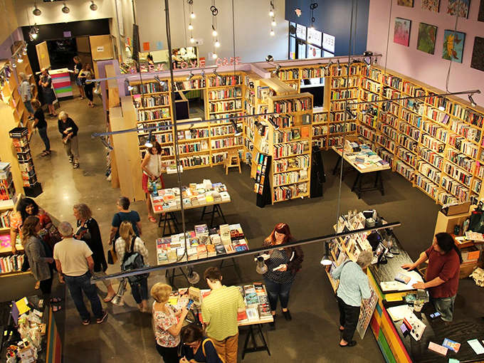 Visitors gather among the stacks, proving that in the age of digital isolation, physical bookstores still create essential human connections.