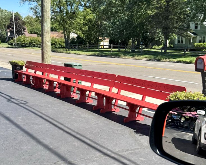 The famous red bench – where strangers become friends over shared appreciation of root beer floats and nostalgia.