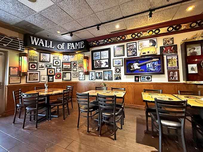 The Wall of Fame displays gold records and portraits, creating a shrine to the artists who defined generations with their music.