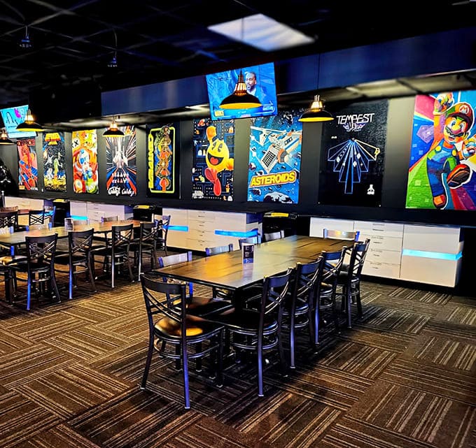 The dining area offers respite beneath gaming artwork, where friends can refuel before diving back into digital battles.