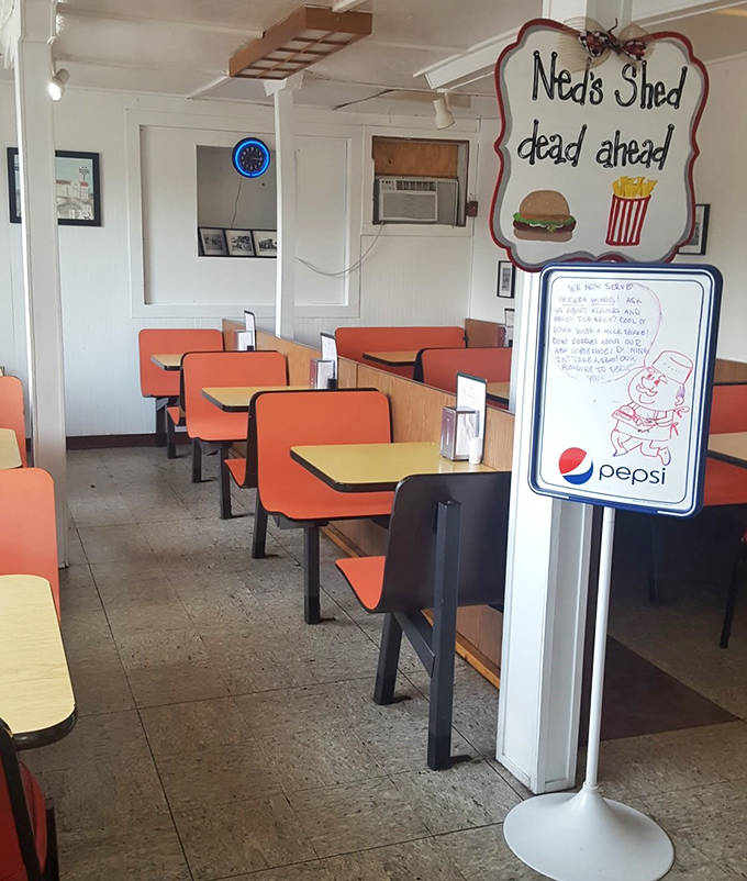 Ned's Shed dead ahead &ndash; the interior signage promises good things to come, while orange booths stand ready for the next round of happy customers.