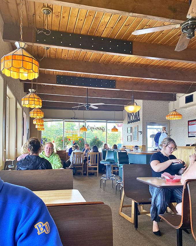 Wooden ceiling beams and honeycomb pendant lights create a cozy atmosphere where time seems to slow down just enough.