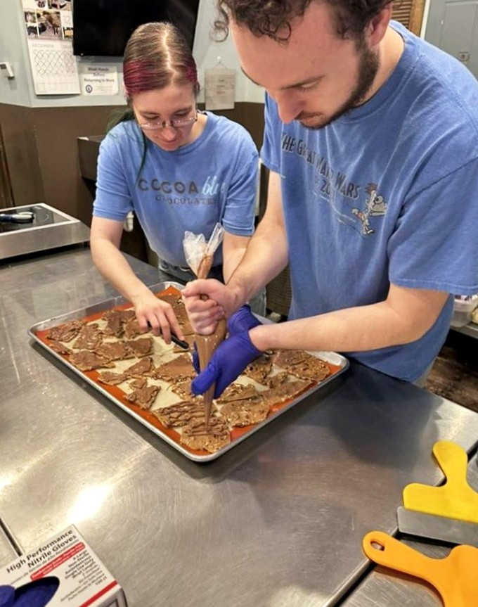 Chocolate artisans at work, crafting sweet masterpieces with the focus and dedication of Renaissance painters, but with tastier results.
