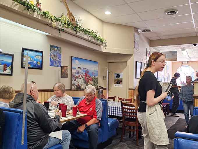 Happy diners enjoying authentic Greek cuisine in a setting that feels like your favorite neighborhood hangout.