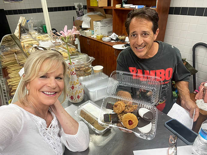 The universal expression of bakery joy&mdash;two happy customers clutching their treasure trove of Italian treats like lottery winners.