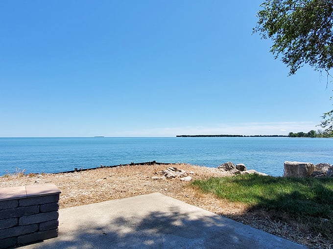Shoreline view with clear blue water: Lake Erie shows off its Caribbean side – crystal waters meeting Ohio shoreline under impossibly blue skies.