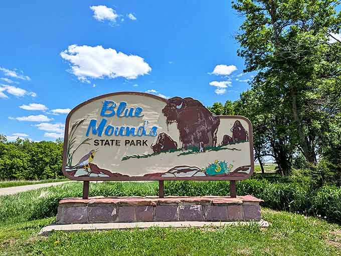 Blue Mounds State Park's iconic sign hints at the natural wonders waiting beyond, including resident bison herds.